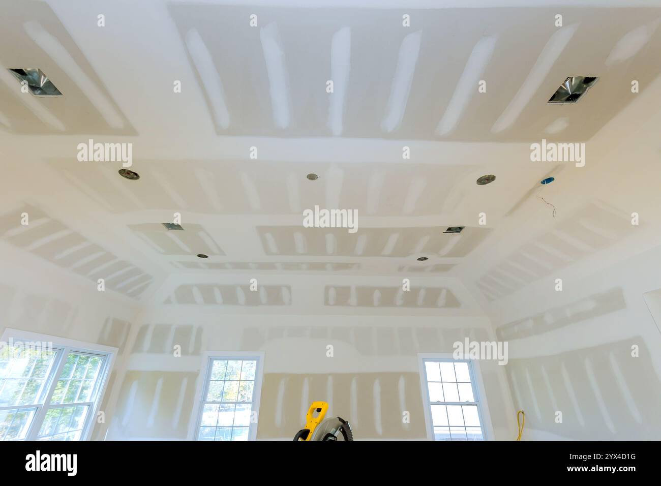 This is an interior room under renovation, with drywall partially ...