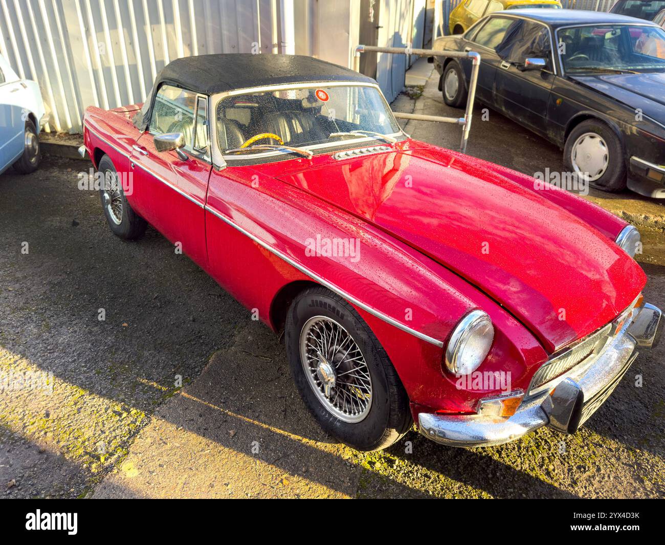 Front view of a classic red MG sports car with a vintage license plate ...