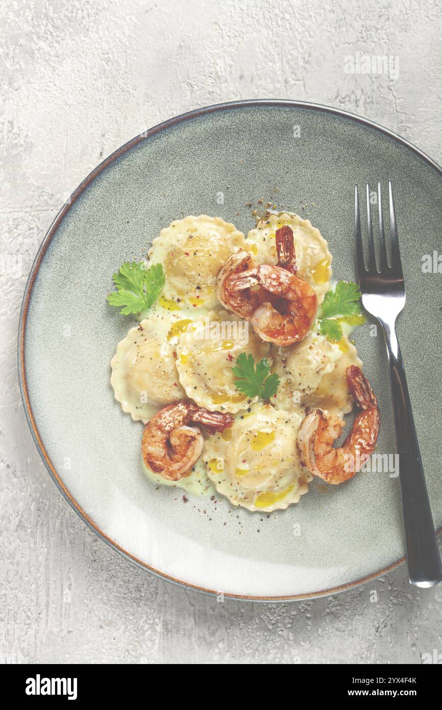 Ravioli with shrimp, in cream sauce, with spices and herbs, top view ...