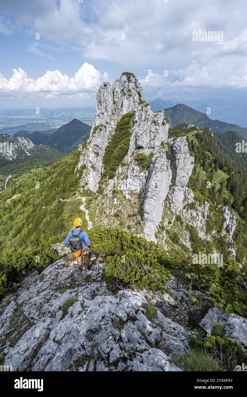 Climber on a climbing tour, on a mountain ridge, behind the summit of ...