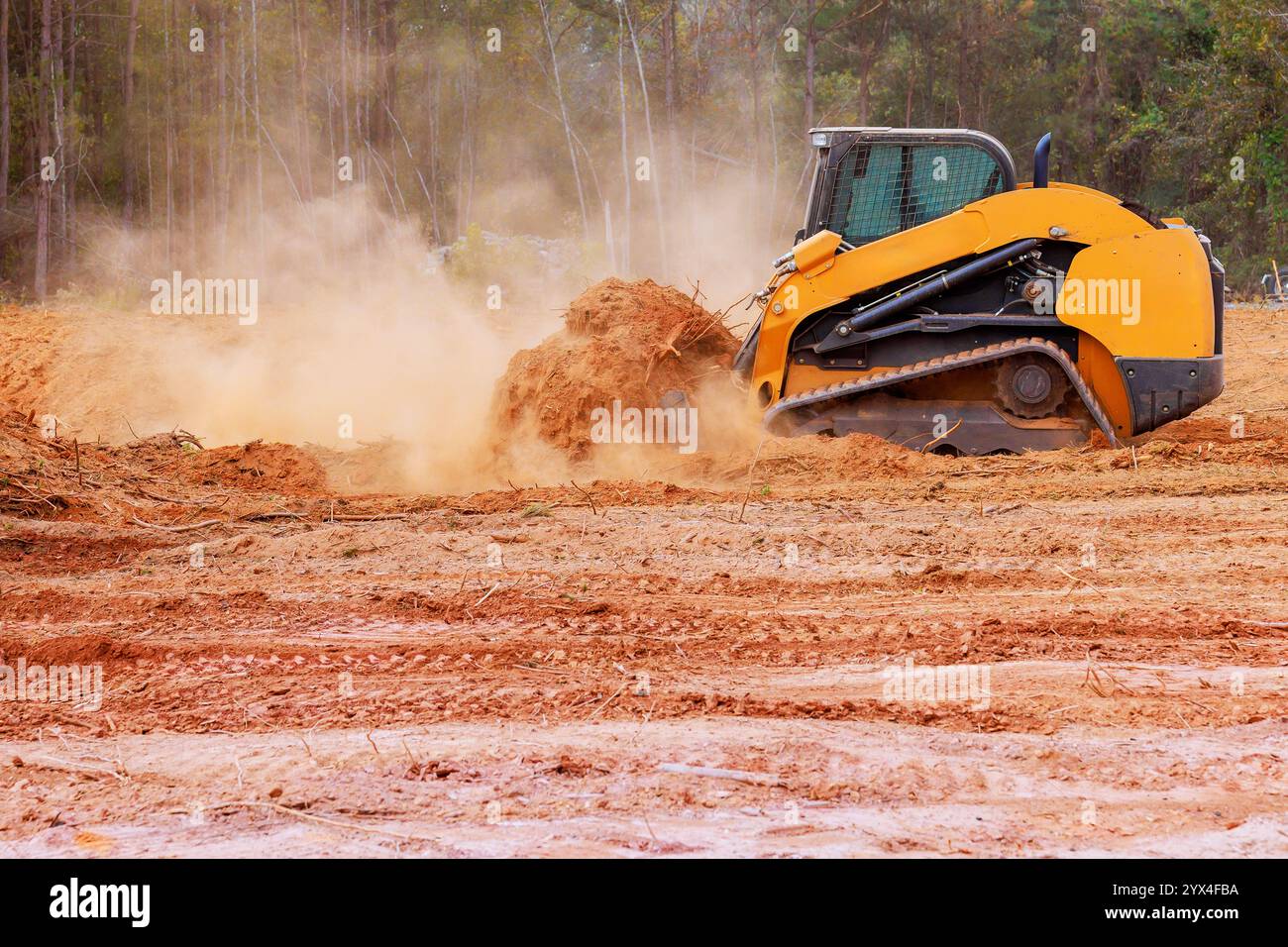 On construction site, bulldozer is leveling ground graded soil for preparing construction Stock ...
