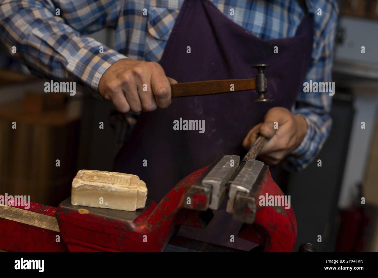 Metal instrument maker forges a soldered brass tube for the slide bow ...