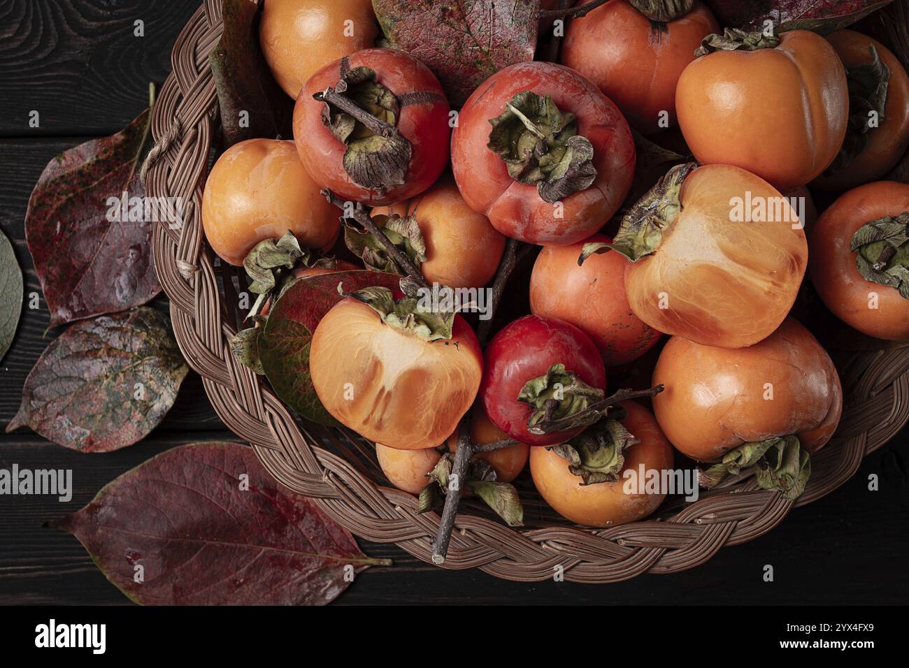 Fresh persimmon in a basket, with leaves, top view, no people Stock ...