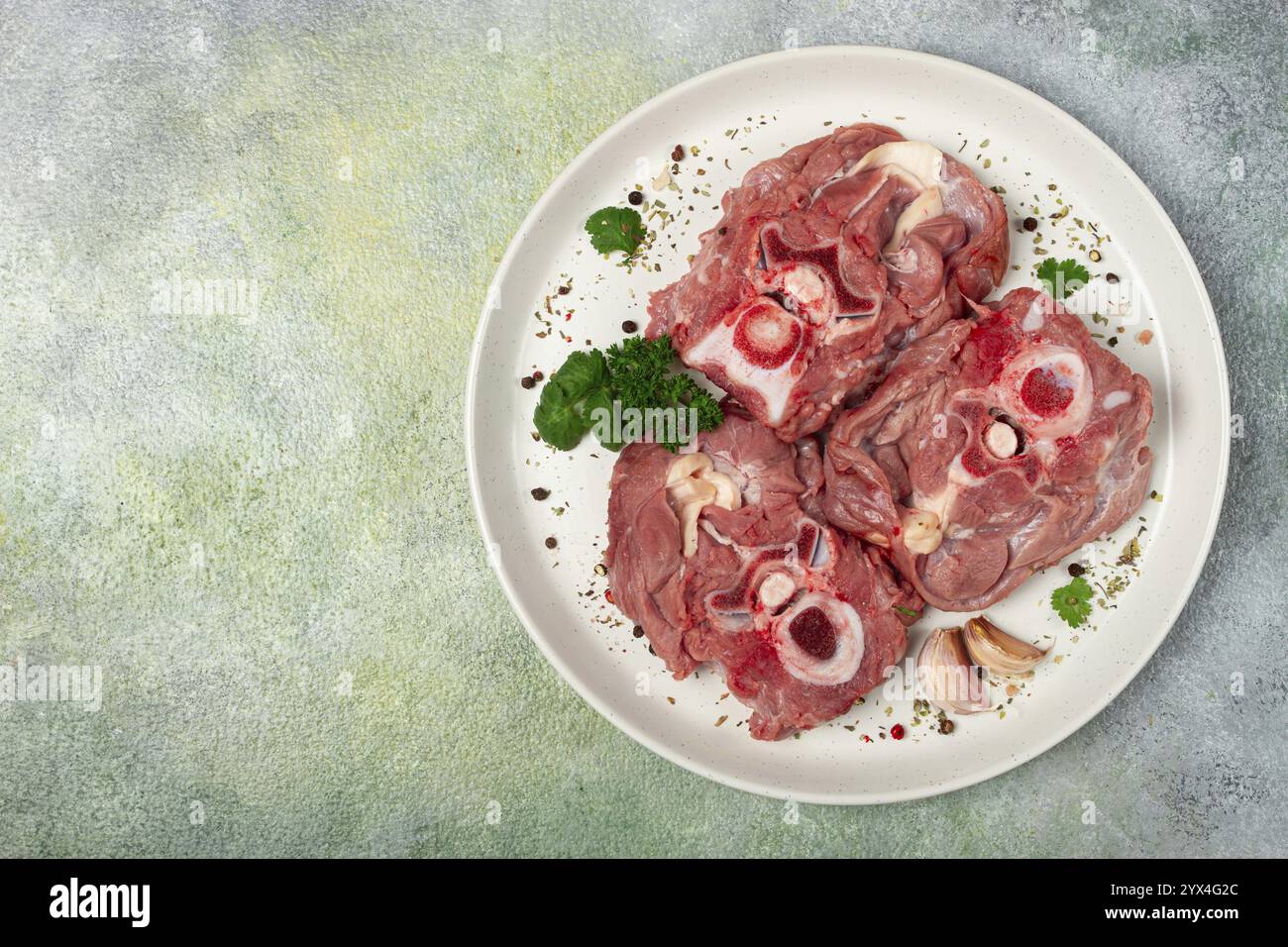 Raw steak, calf's neck on the bone, fresh meat, on a white plate, top ...