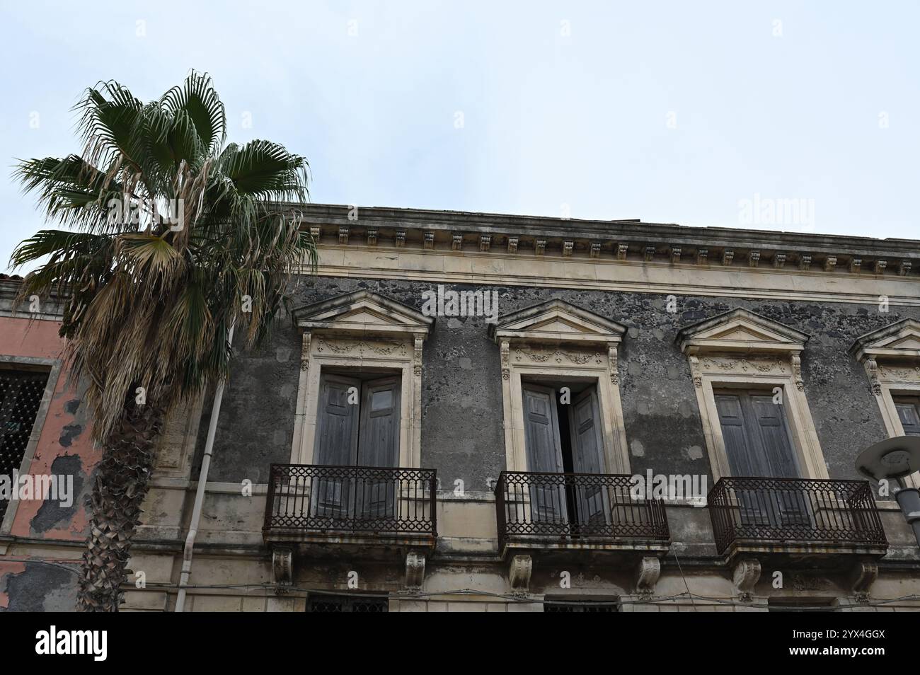 Charming buildings line the streets of Giarre, Sicily, showcasing ...