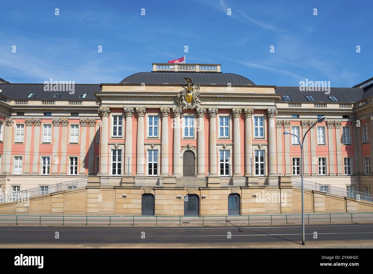 Historic building with baroque facade and columns under a blue sky ...