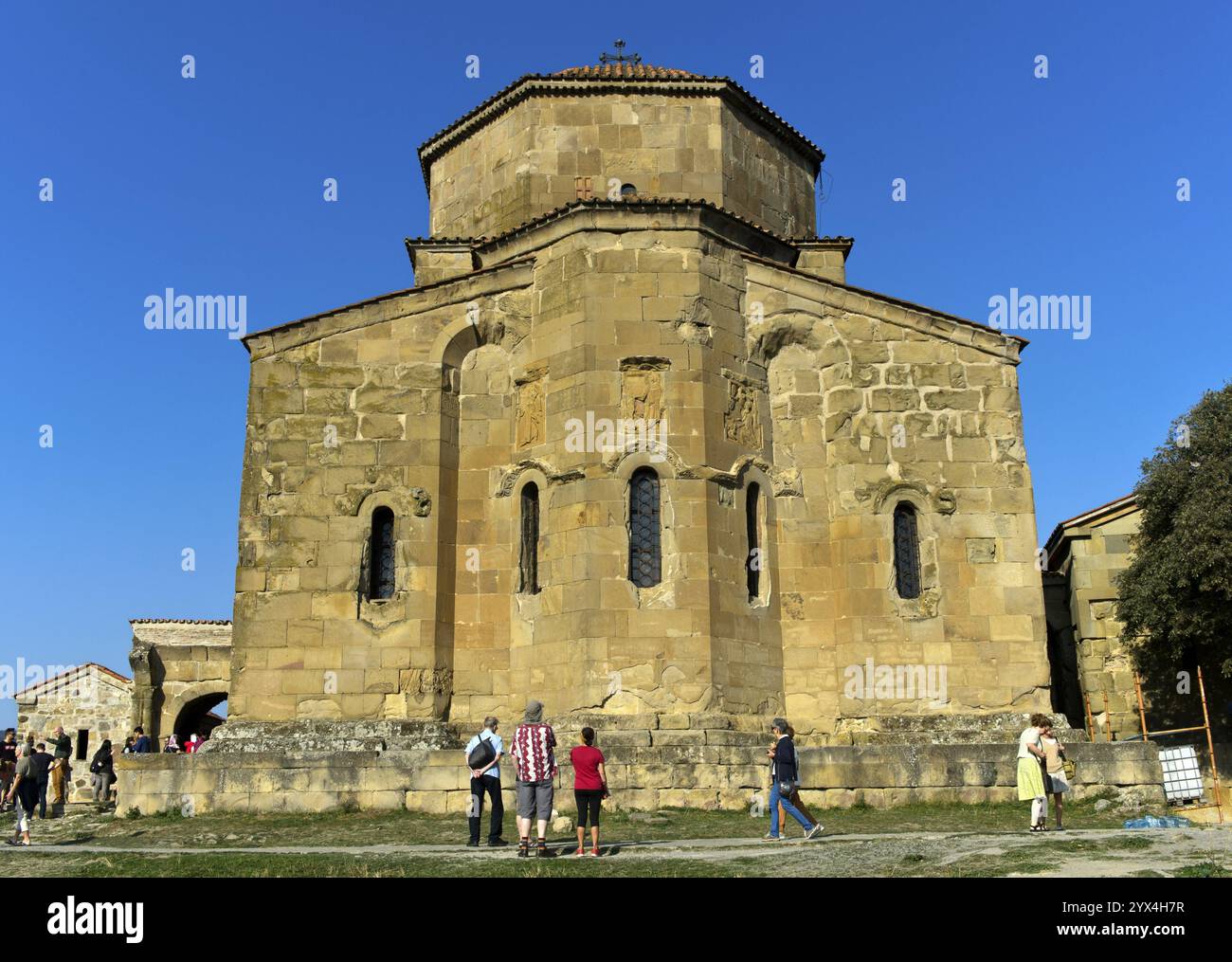 Tourists look at the east facade of the Jvari Church of the Cross ...