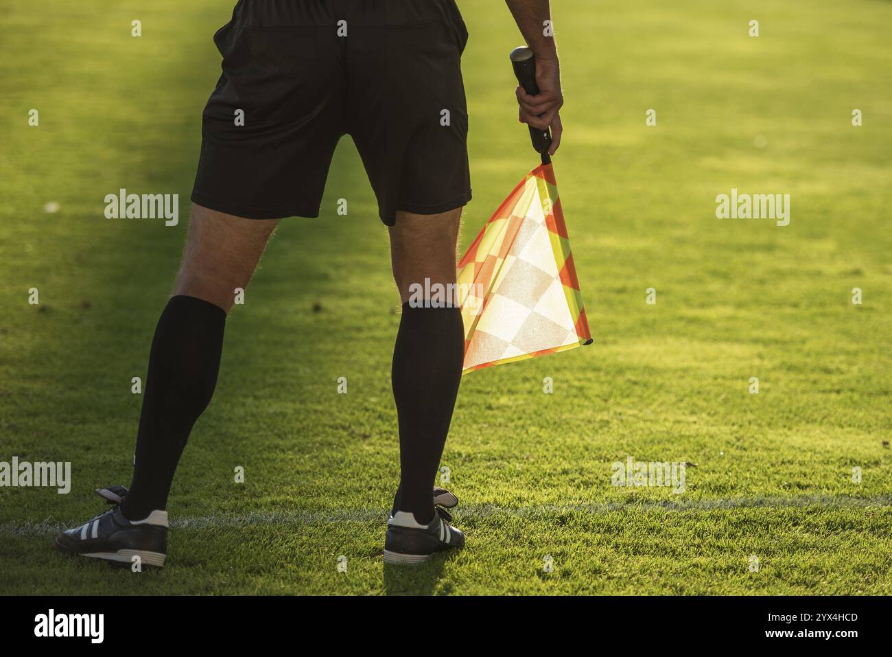 Soccer touchline referee - detail of legs and hand with the flag Stock ...