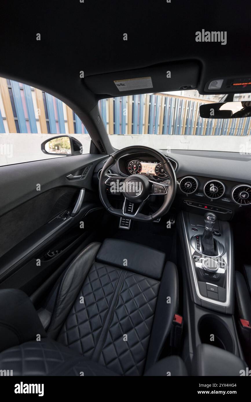 Driver's seat in Audi TT coupe. First person view: black leather seats ...