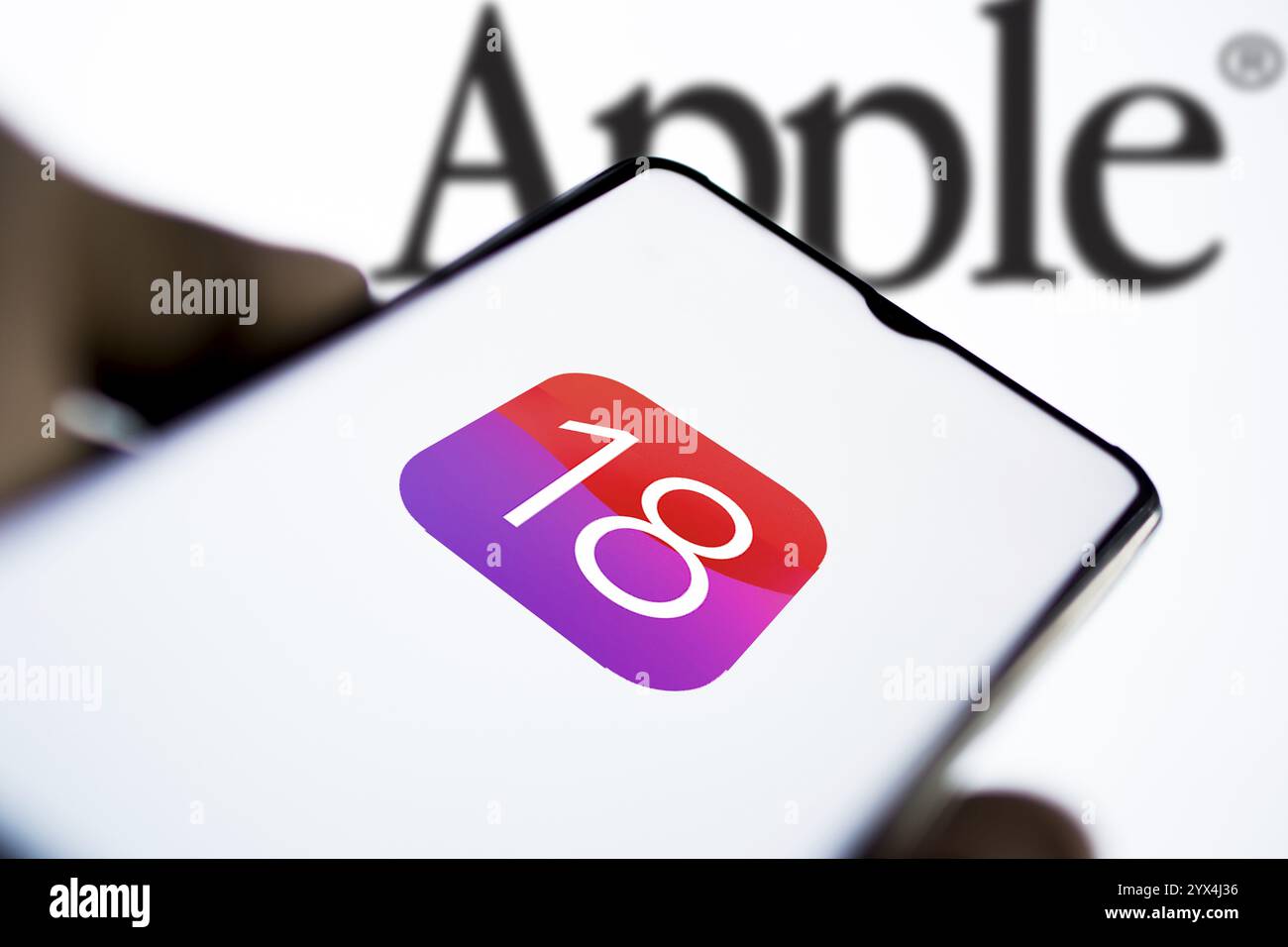 Apple IOS 18 icon on smartphone and Apple logo on the background Stock ...