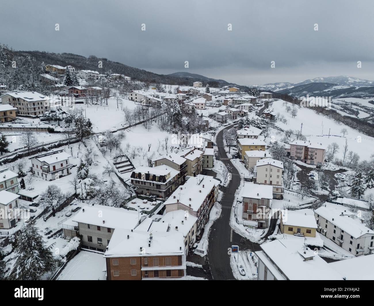 Aerial view of bore, a village in the province of parma covered by snow ...