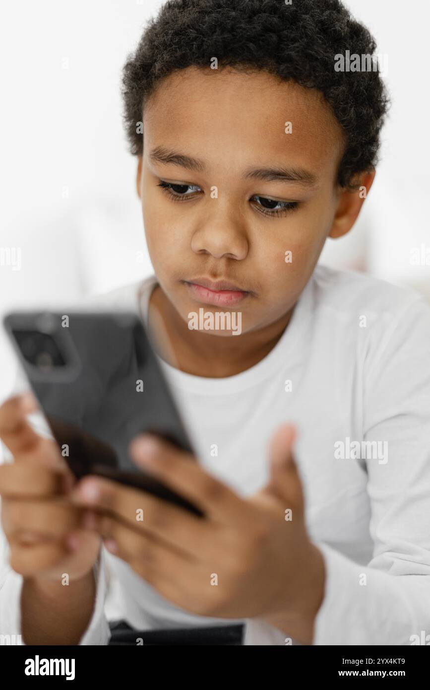 Young boy kid using mobile Stock Photo - Alamy