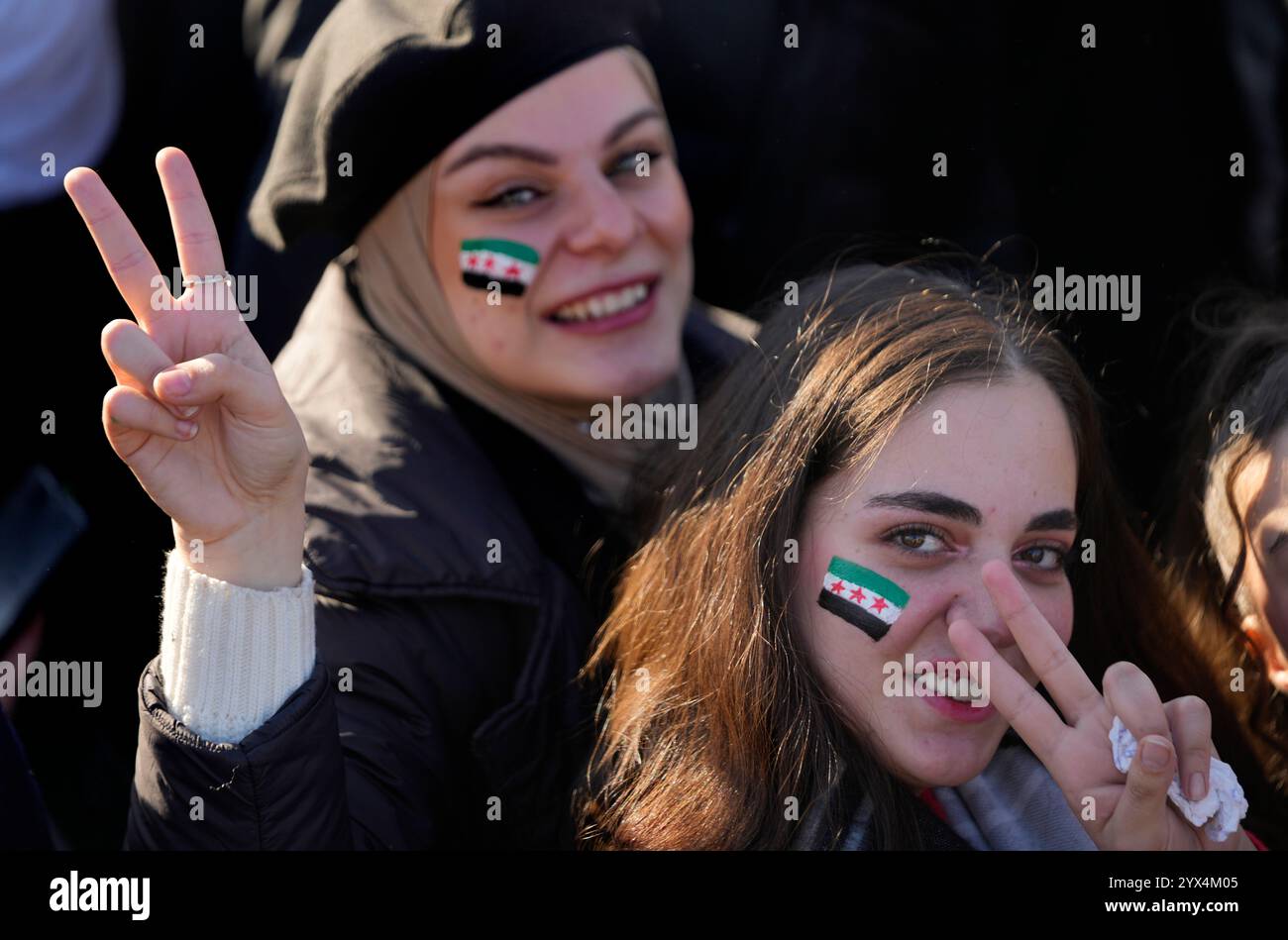 Syrian women flash victory signs with the colour of "revolutionary ...