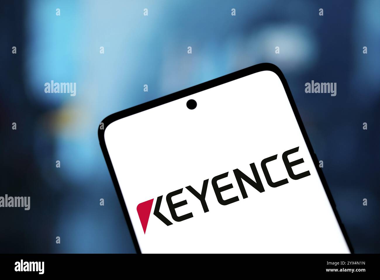 Keyence logo is displayed on smartphone. Keyence is a Japanese company ...