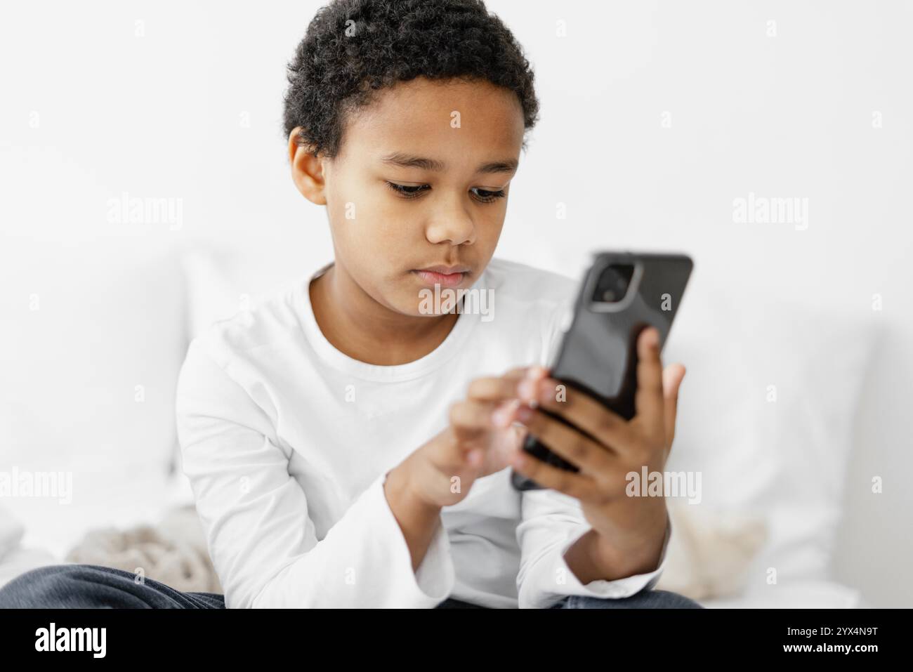 Young boy kid using mobile 2 Stock Photo - Alamy