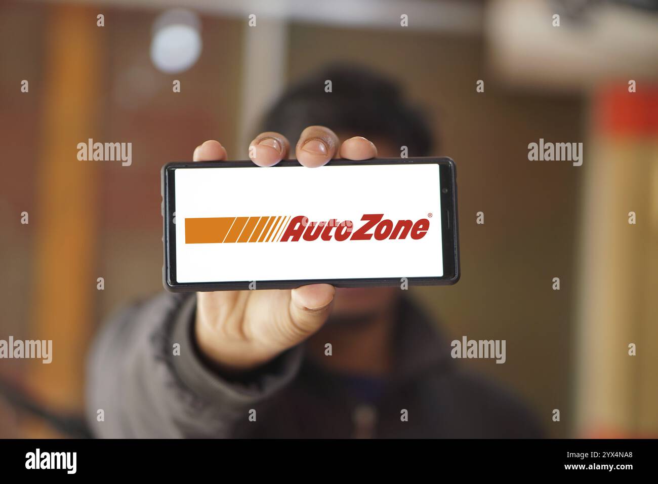 AutoZone logo on man handset Stock Photo - Alamy