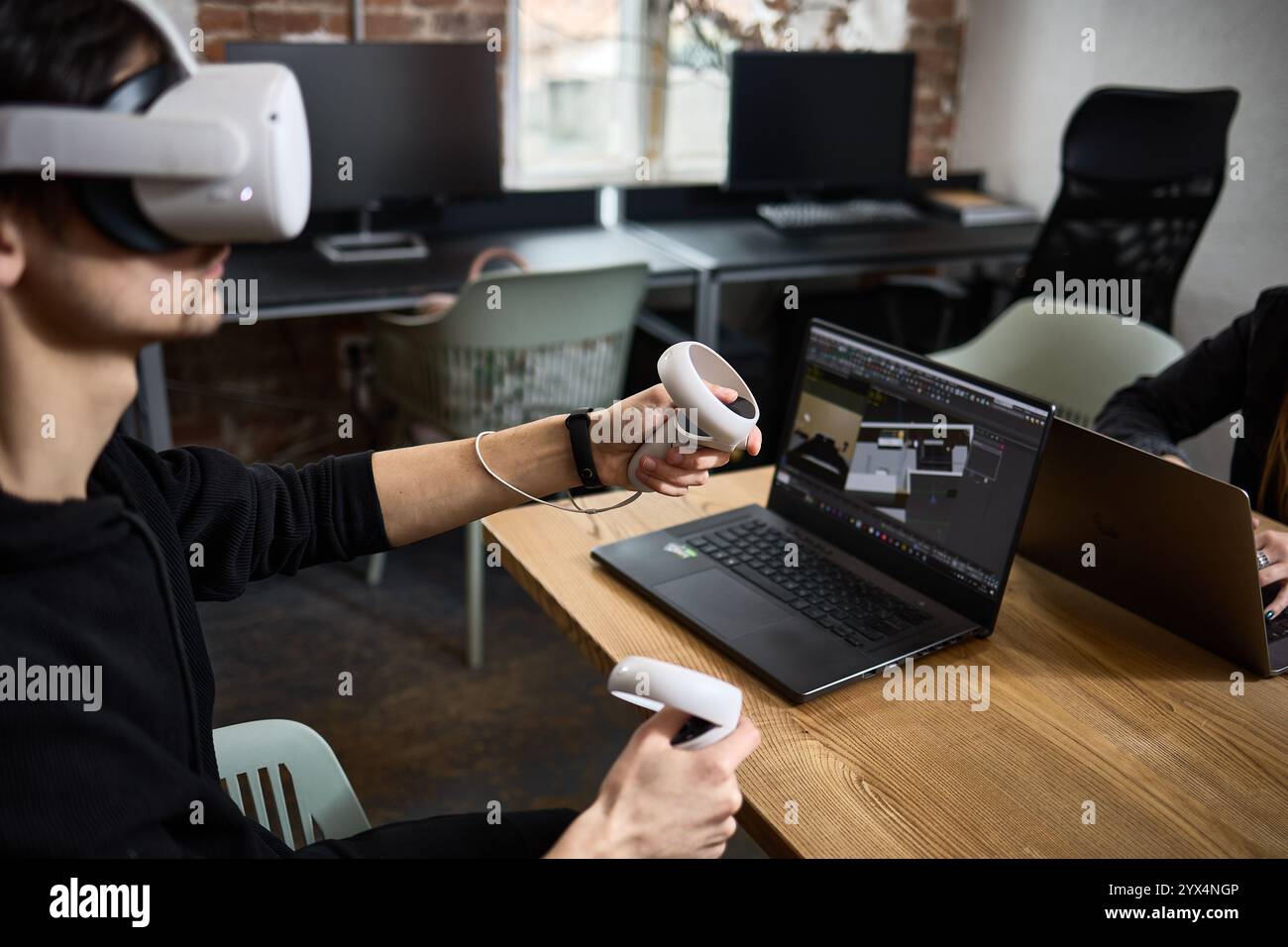 Individual wearing VR headset with hand controllers in a contemporary ...