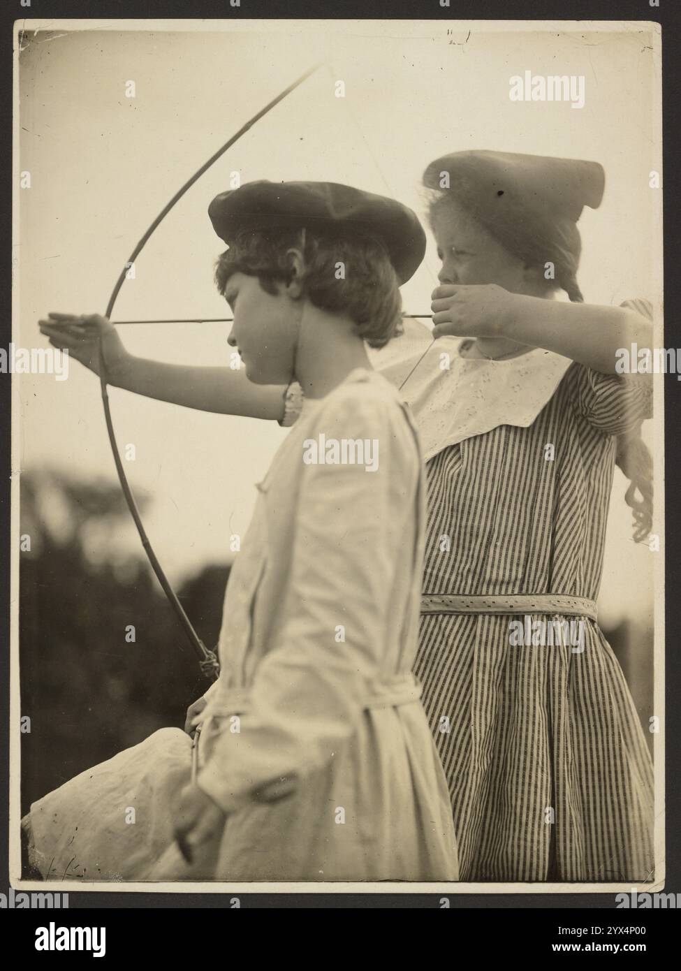 Two child archers, 1900-1930. Portrait of two children, one of whom is ...