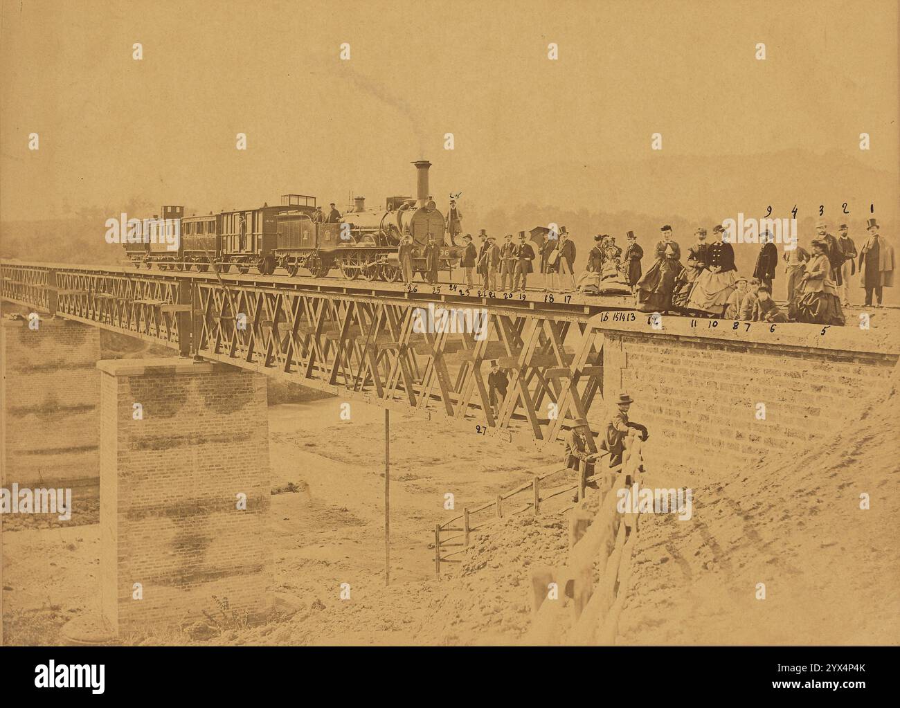 Group portrait with train on bridge, 1865. Group portrait of men and ...