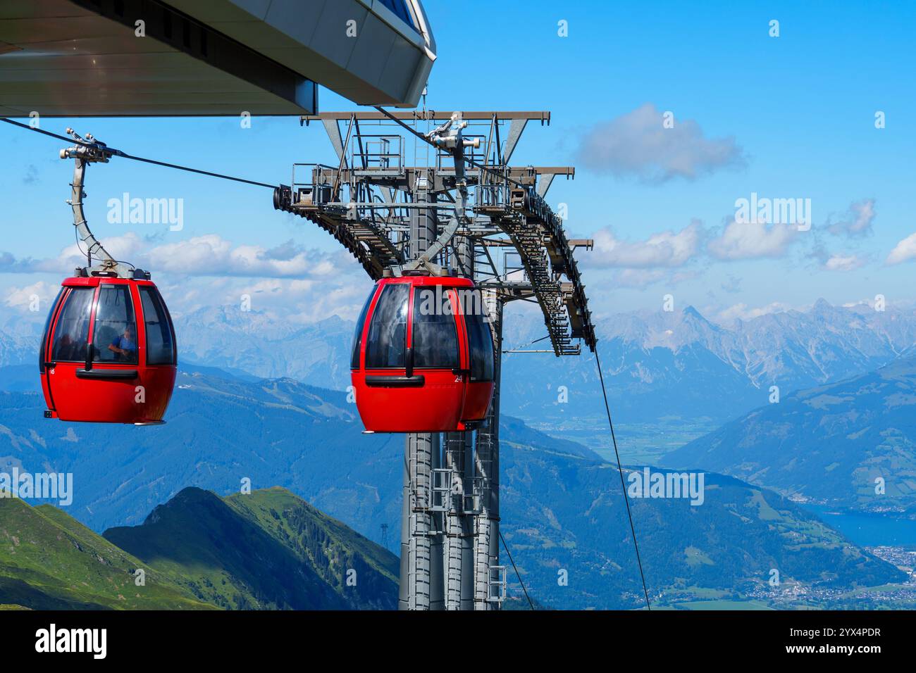 Modern red cable car cabins with a view of the Austrian Alps in Kaprun ...