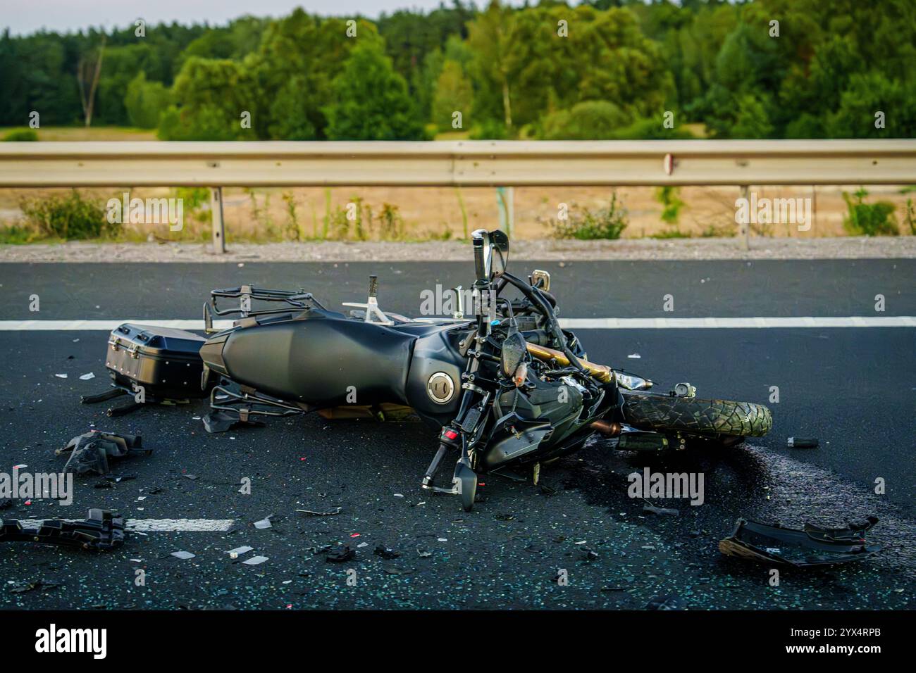 Black modern motorcycle laying on its side after an accident on an ...