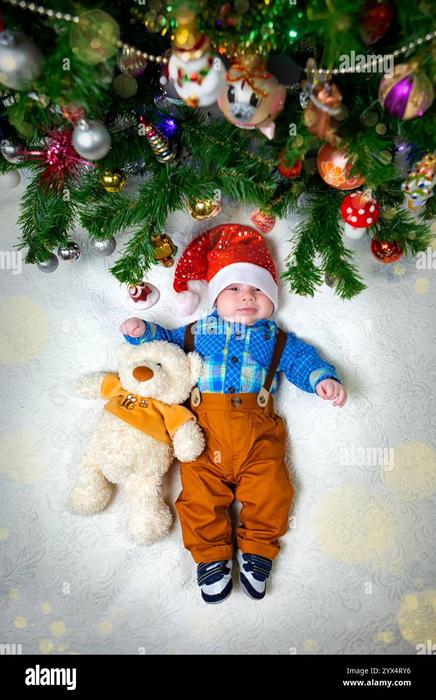 Baby Celebrating Christmas Under the Tree With a Teddy Bear and Festive ...