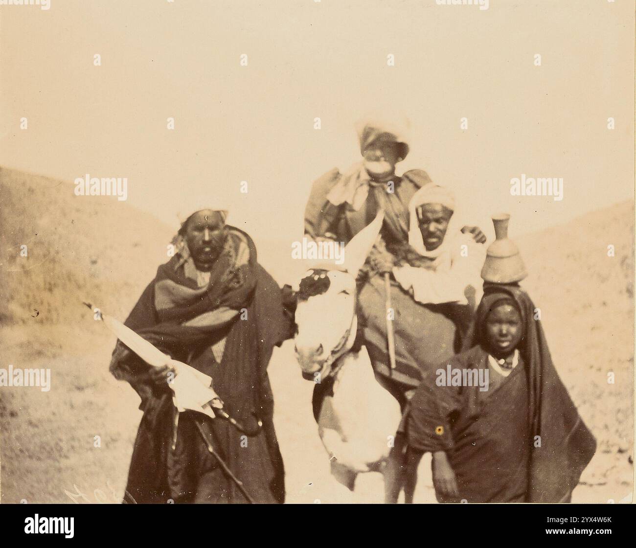 Men with woman riding mule, about 1860-1880. Additional Info: A group ...