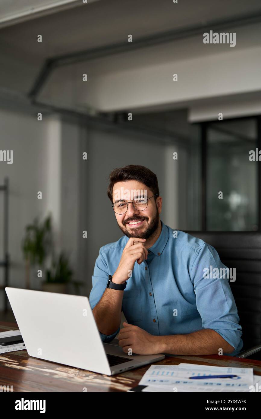 Vertical portrait of happy young business man startup founder working ...