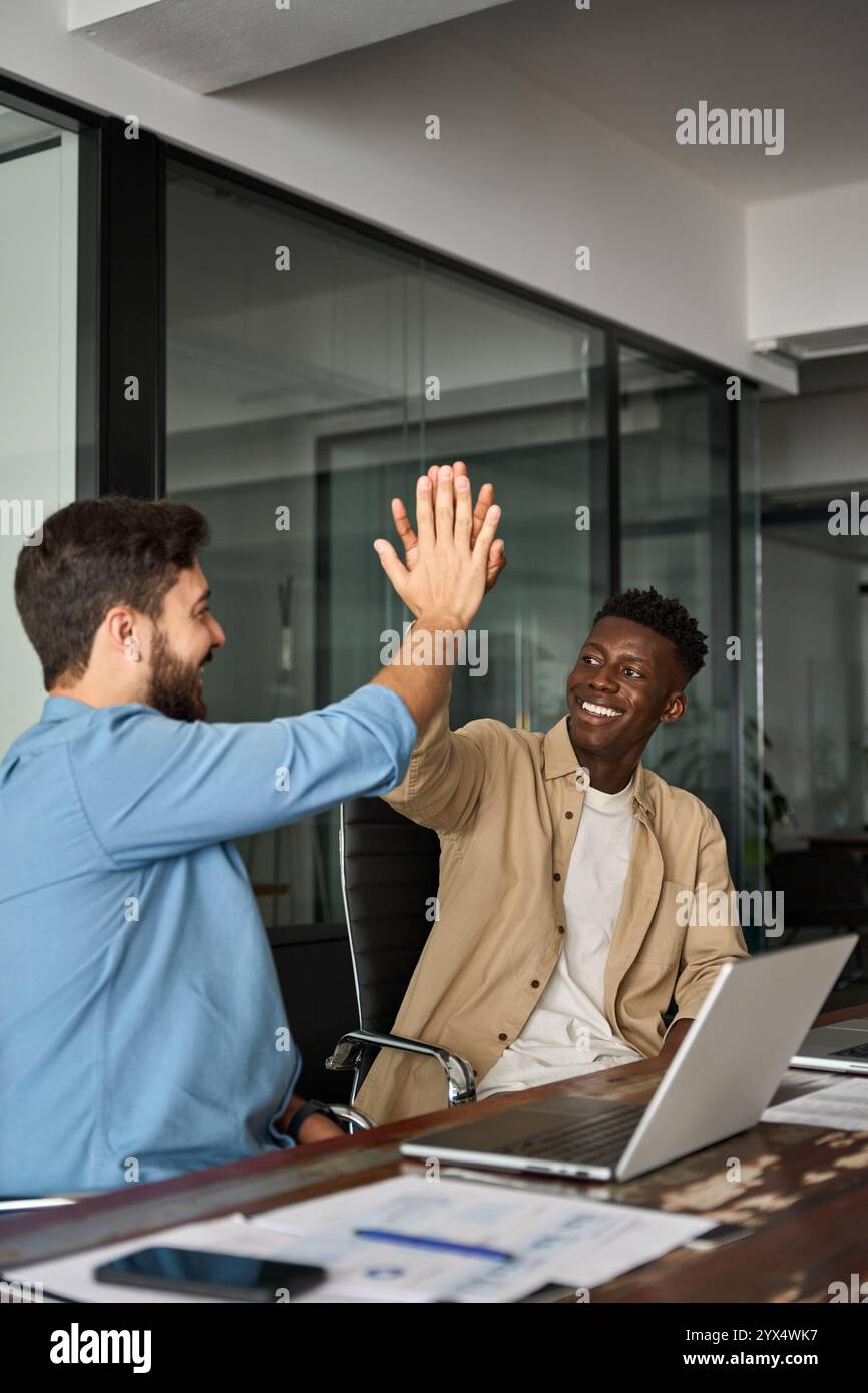 Happy diverse young business men colleagues work team partners giving ...