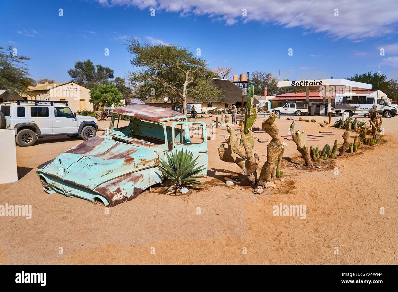 Rusty old car half submerged into the sand of a desert, Car wrecks of ...