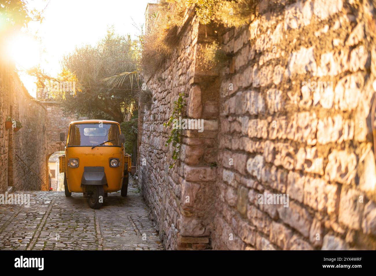 Vintage auto rickshaw parked on the cobbled streets of a hilltop town ...
