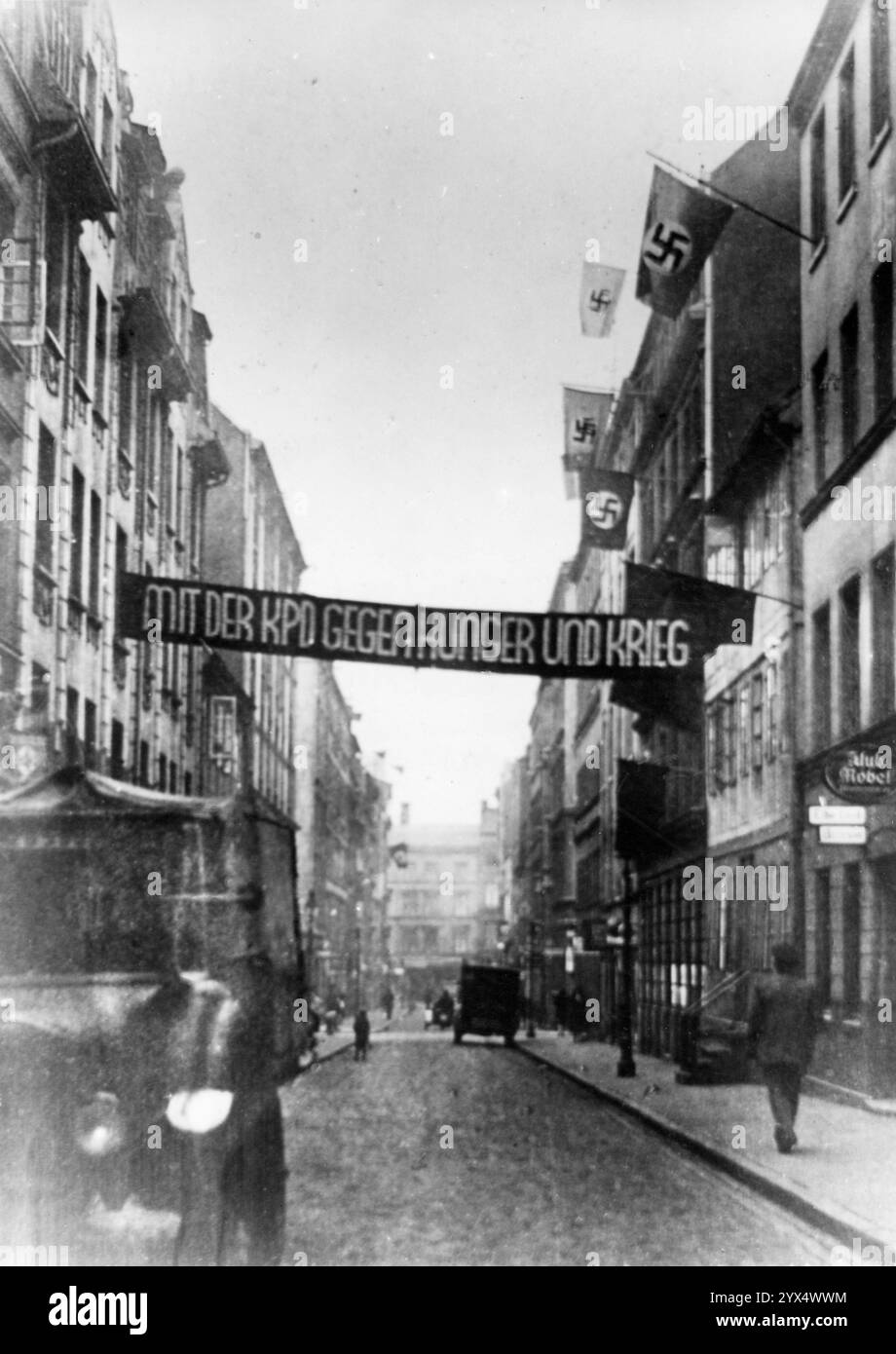 Hamburg St. Georg: KPD street banner next to swastika flags. [automated ...