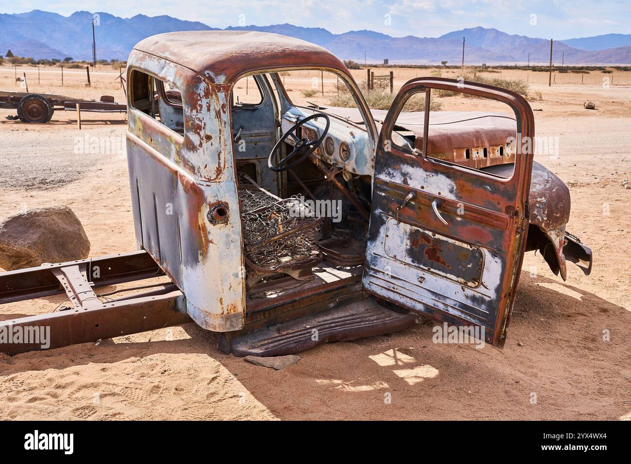 Rusty shell of an old car, no windows, flat tyres, Car wrecks of ...