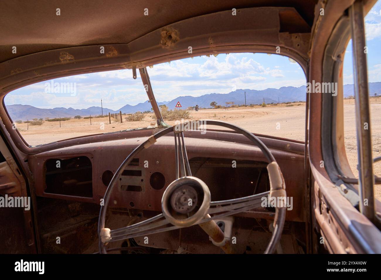 Inside view of a old demolished car, driving wheel and look at the ...