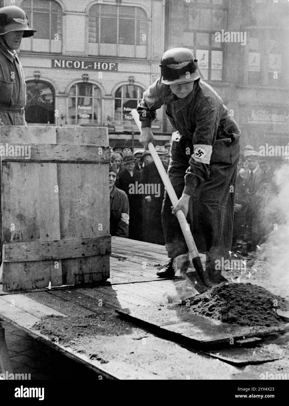 The extinguishing of a fire caused by an incendiary bomb is shown on an ...