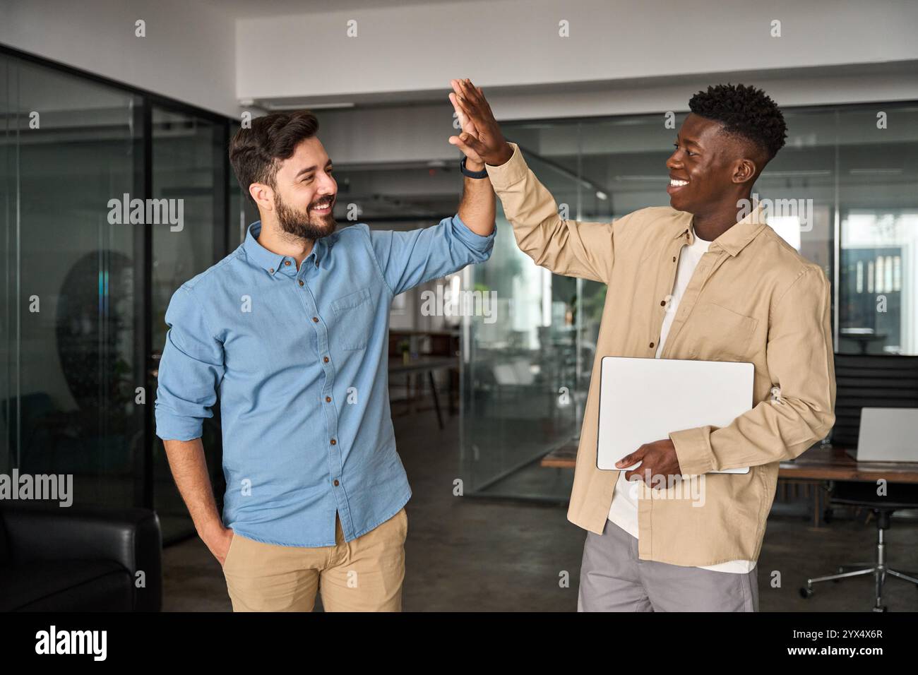 Two diverse happy professional business men team giving high five in ...