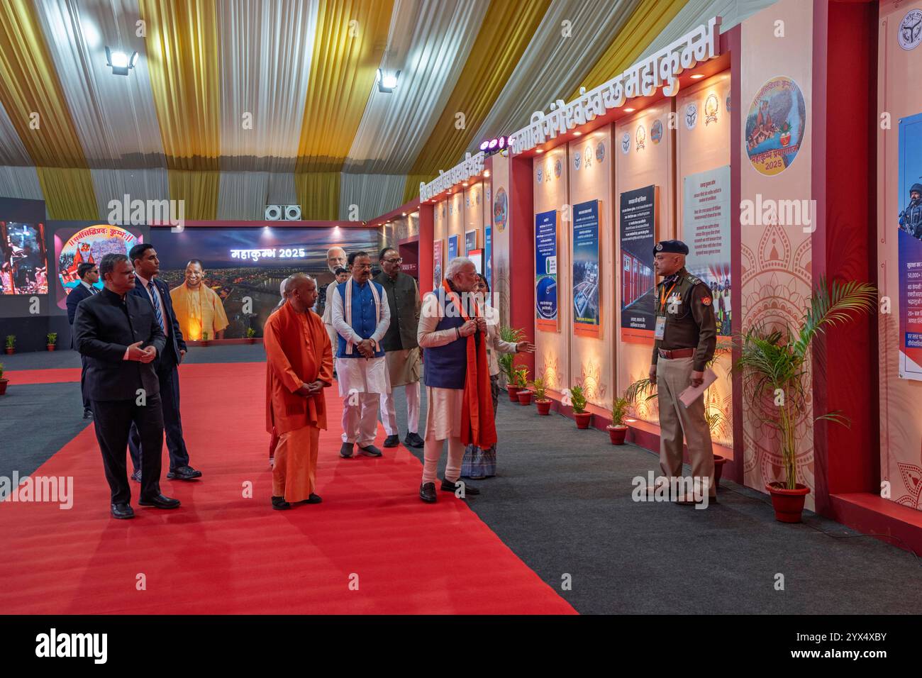 Indian Prime Minister Narendra Modi, center right, holds his scarf as ...