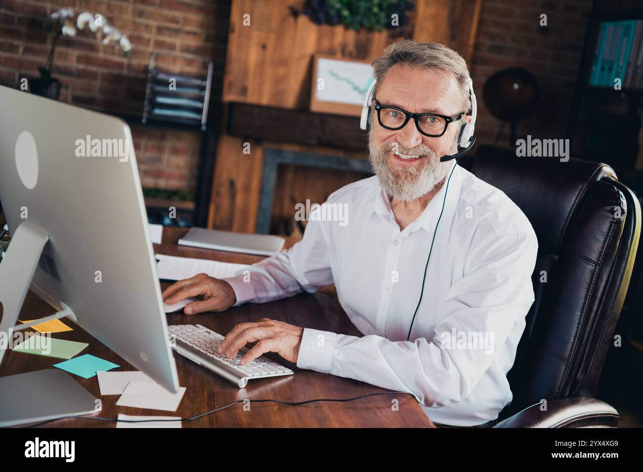 Photo of nice old man call center briefing video call wear white shirt ...