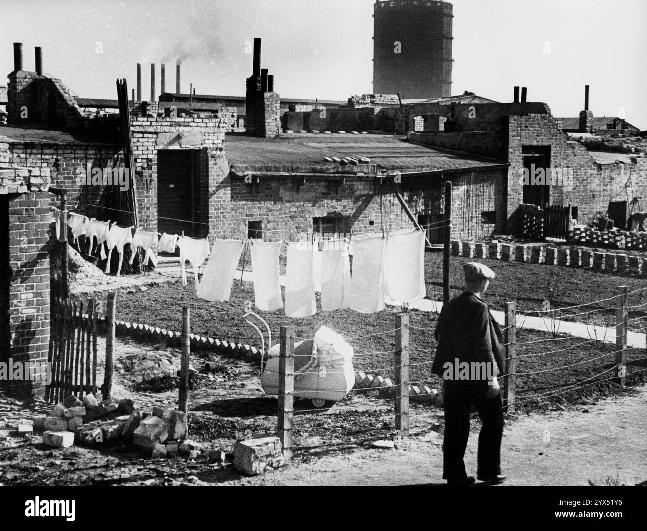 Laundry drying on the washing line in the front garden of a ruined ...