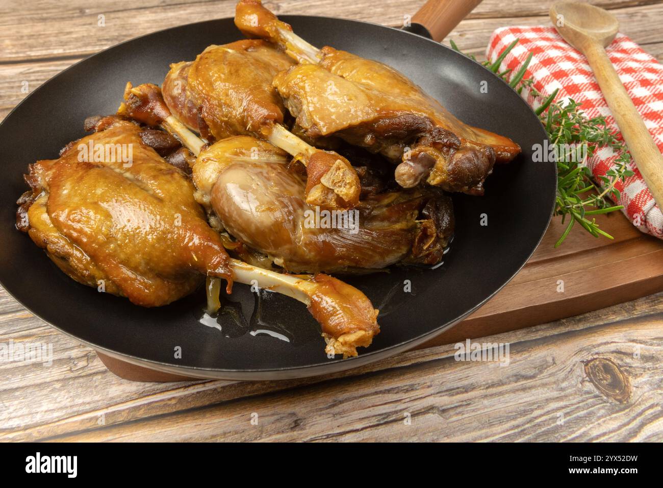 duck legs confit, cooking in a pan Stock Photo - Alamy