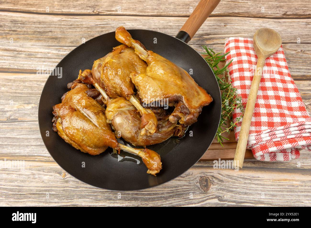 duck legs confit, cooking in a pan Stock Photo - Alamy