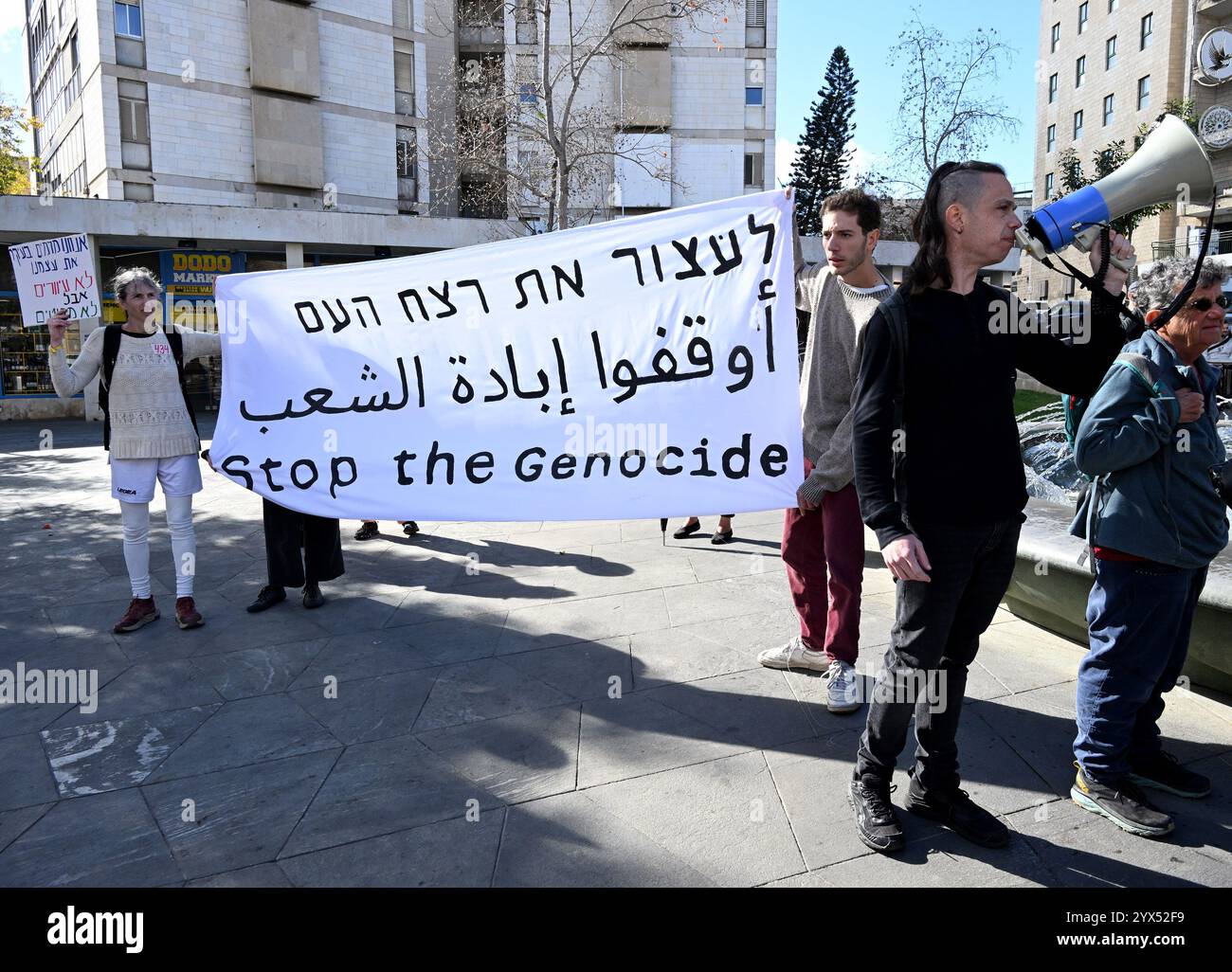 Jerusalem, Israel. 13th Dec, 2024. People hold placards calling for ...