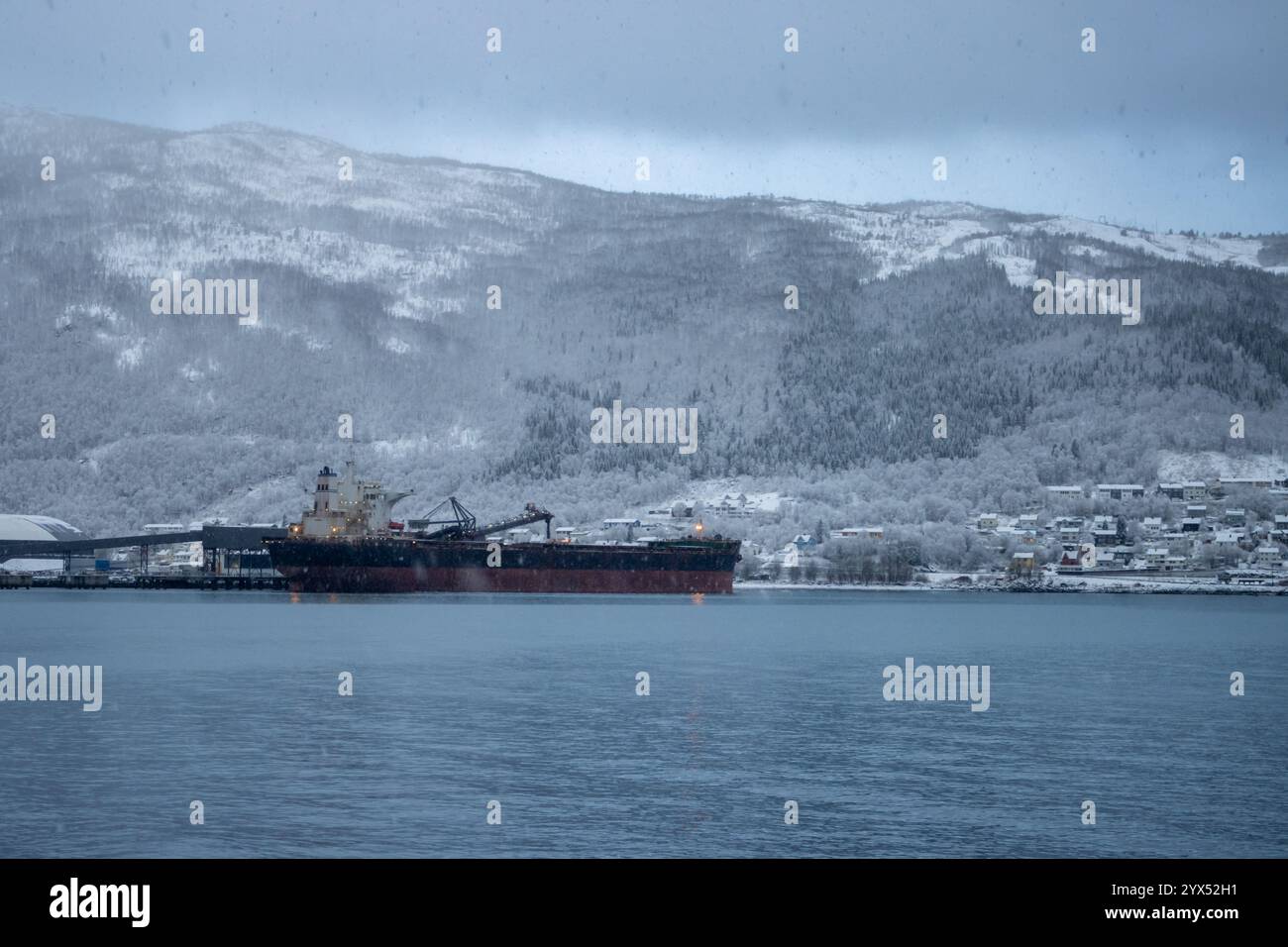 Blue water of the Norwegian sea. Bay with a harbor and a big boat ...