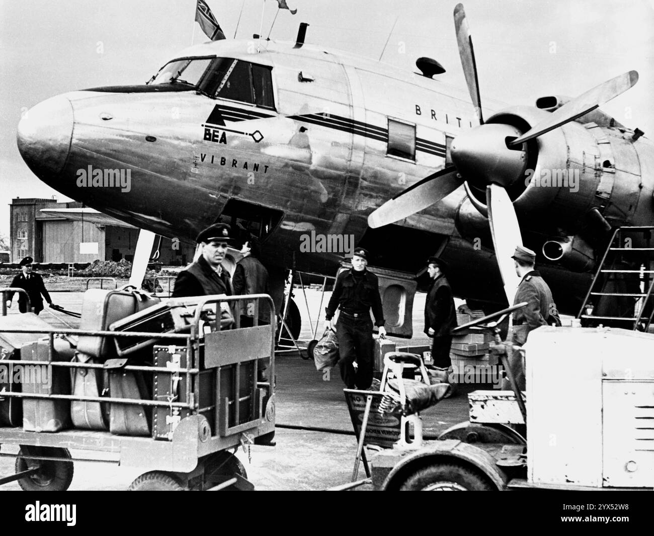 A British European Airways (BEA) aircraft with baggage trolley at ...