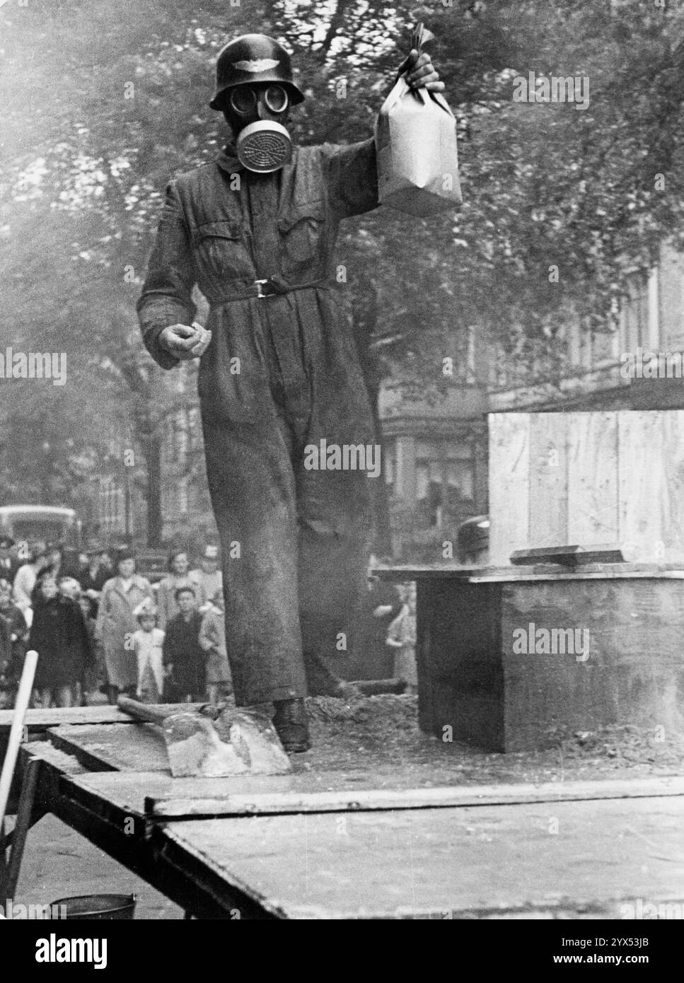 The extinguishing of a fire caused by an incendiary bomb is shown at an ...