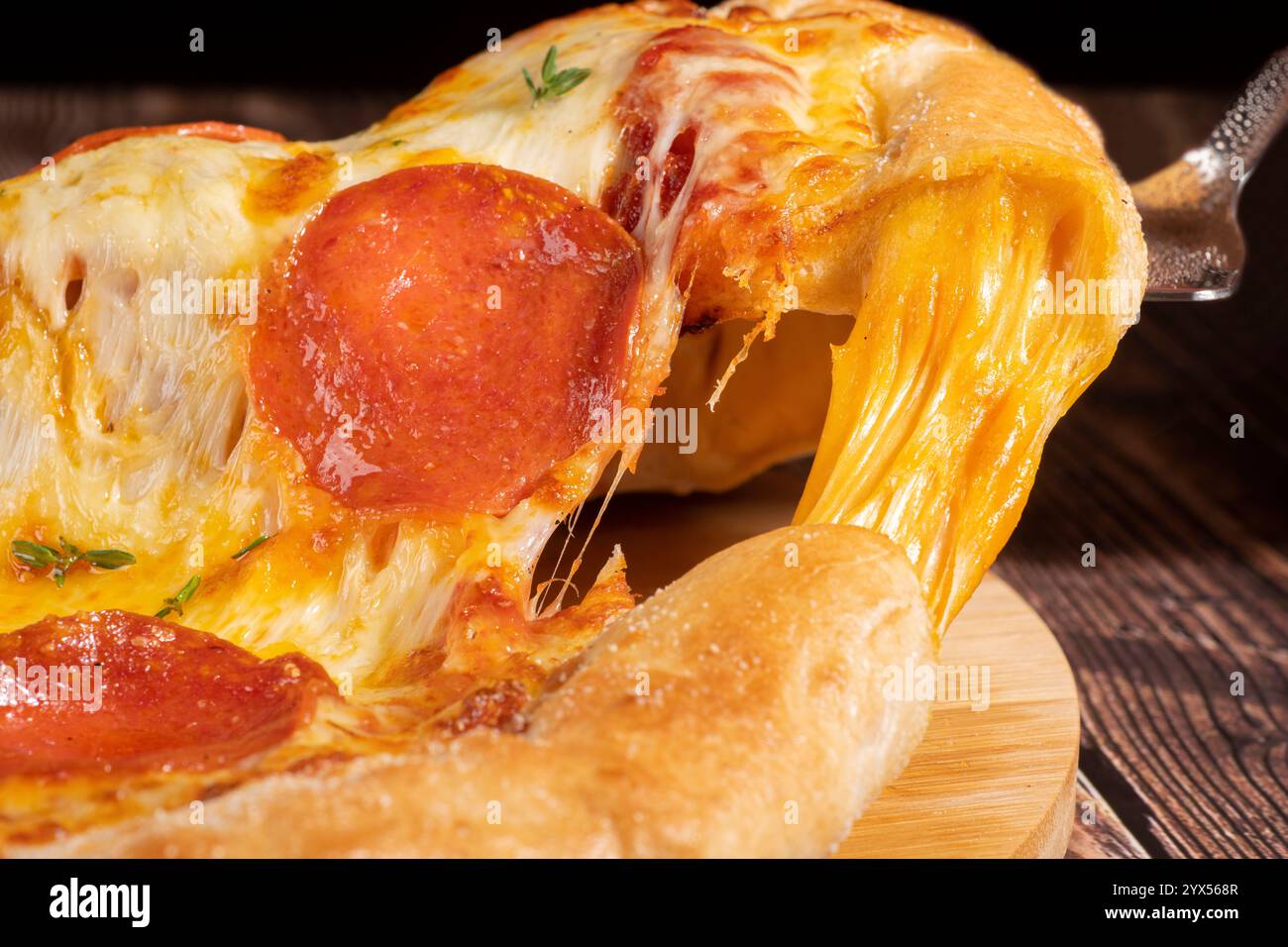 Server lifting slice of hot pepperoni pizza with melted cheese Stock ...