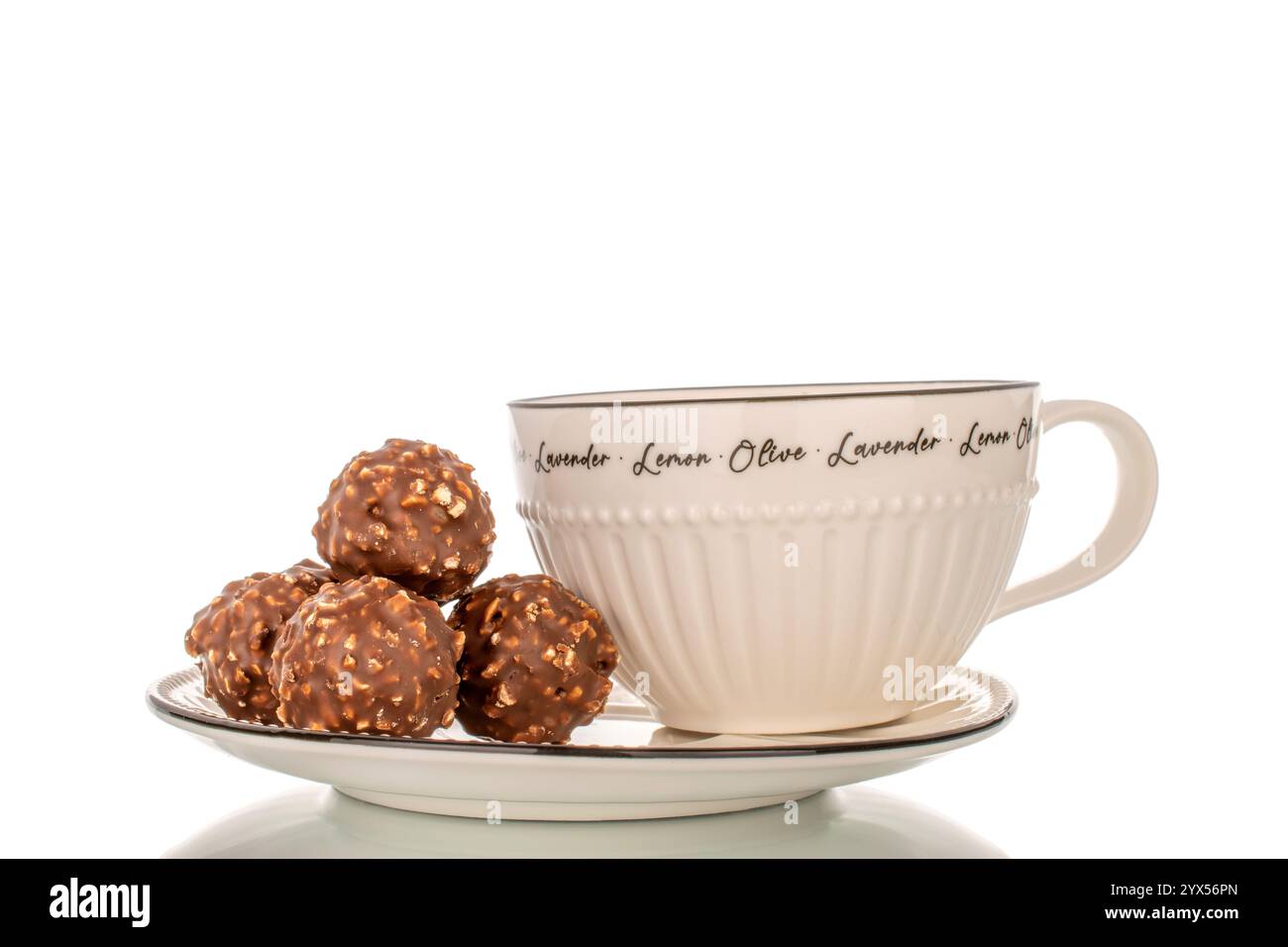 Chocolate candies with hazelnuts with ceramic dishes, close-up ...