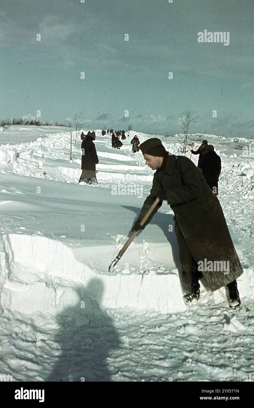 Soldiers of the 110th Infantry Division work on clearing snow from the ...