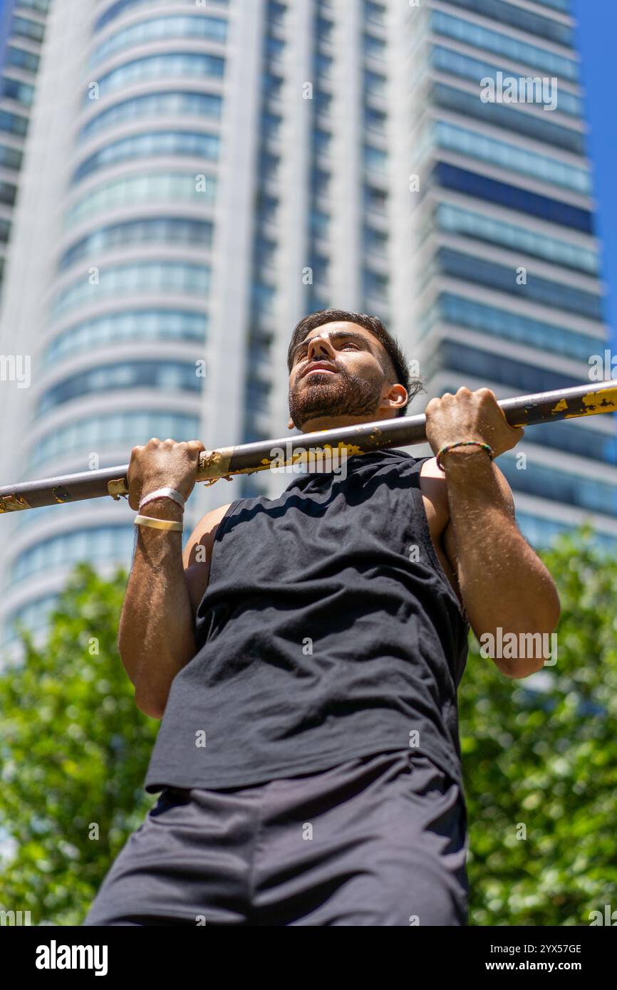 Young athlete performing pull-ups on outdoor gym bars Stock Photo - Alamy