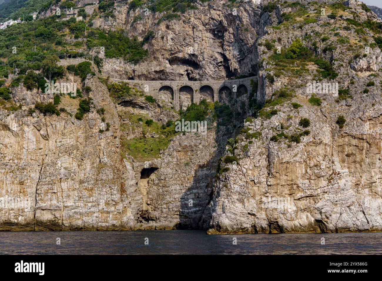 A beautiful old stone viaduct, built on the side of a steep cliff ...